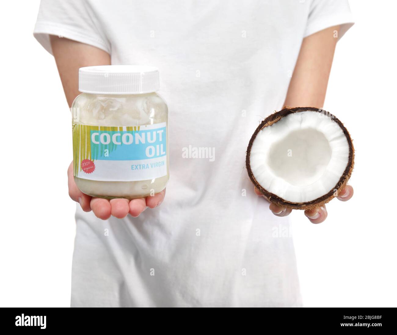 Young woman with coconut oil on white background, closeup Stock Photo ...