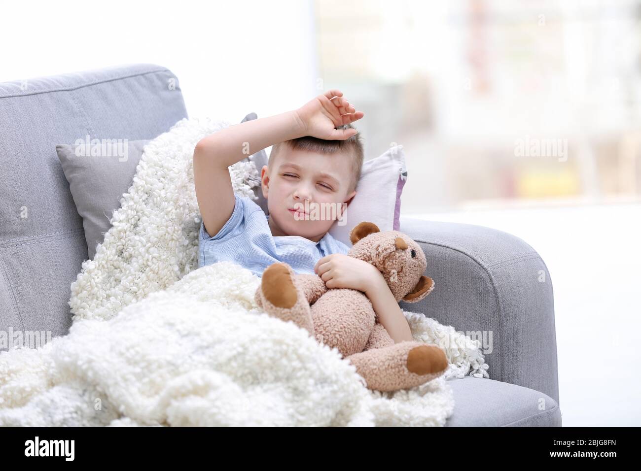 Little boy suffering from headache at home Stock Photo - Alamy