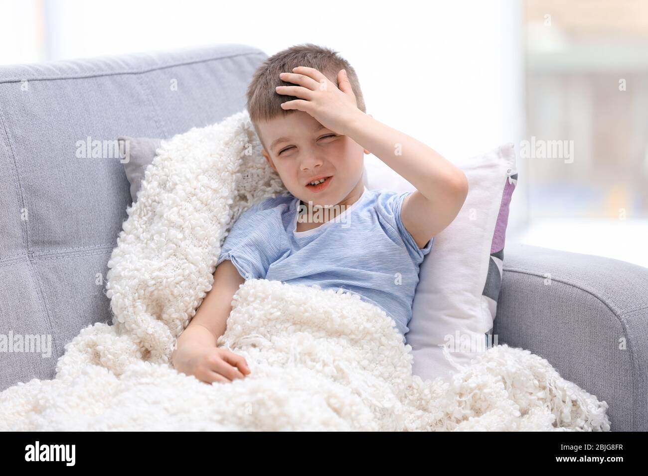 Little boy suffering from headache at home Stock Photo - Alamy