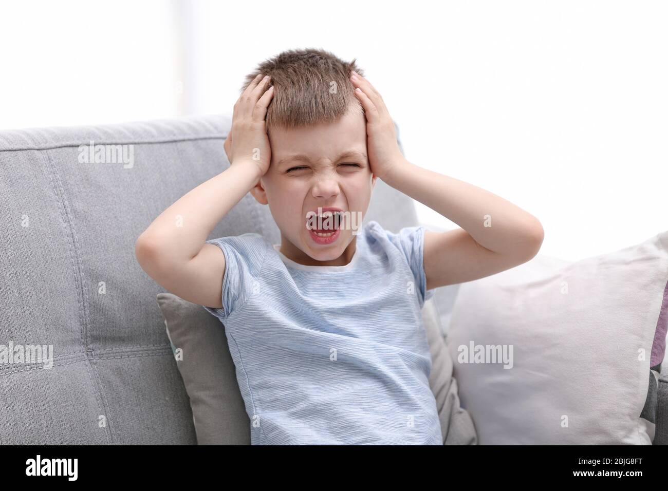 Little boy suffering from headache at home Stock Photo - Alamy