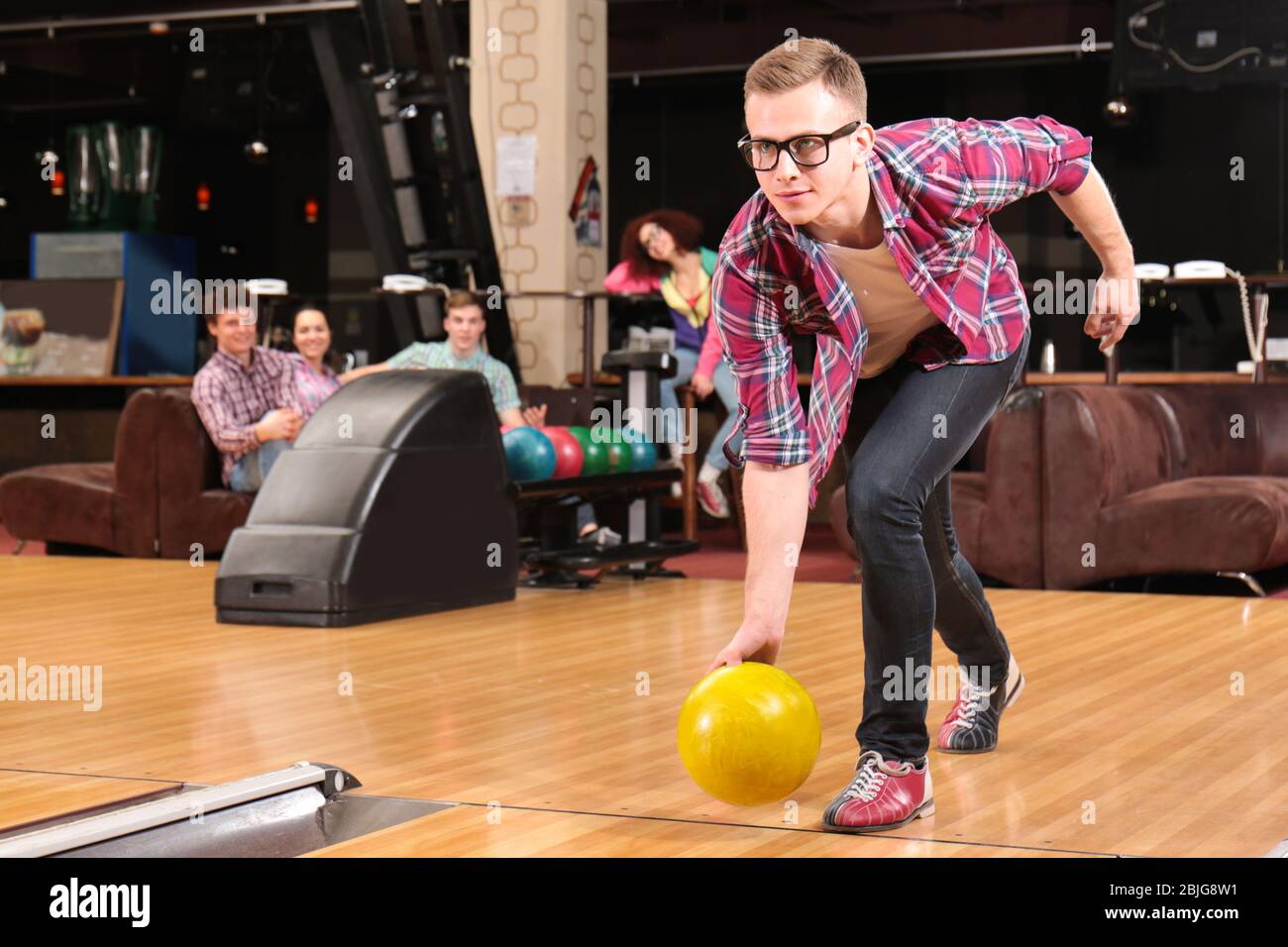 Young man having fun and playing bowling Stock Photo - Alamy