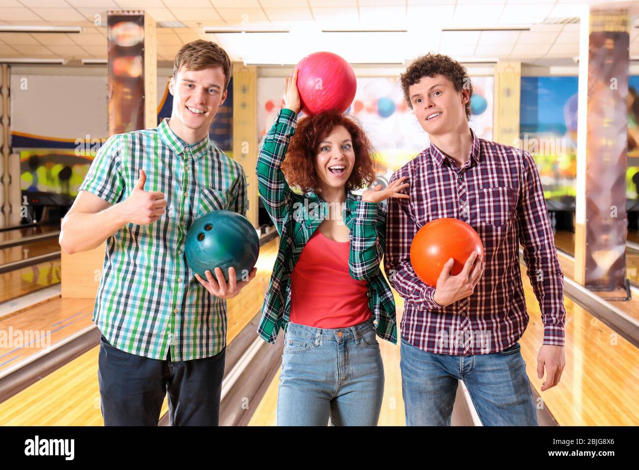 Friends having fun in bowling Stock Photo - Alamy