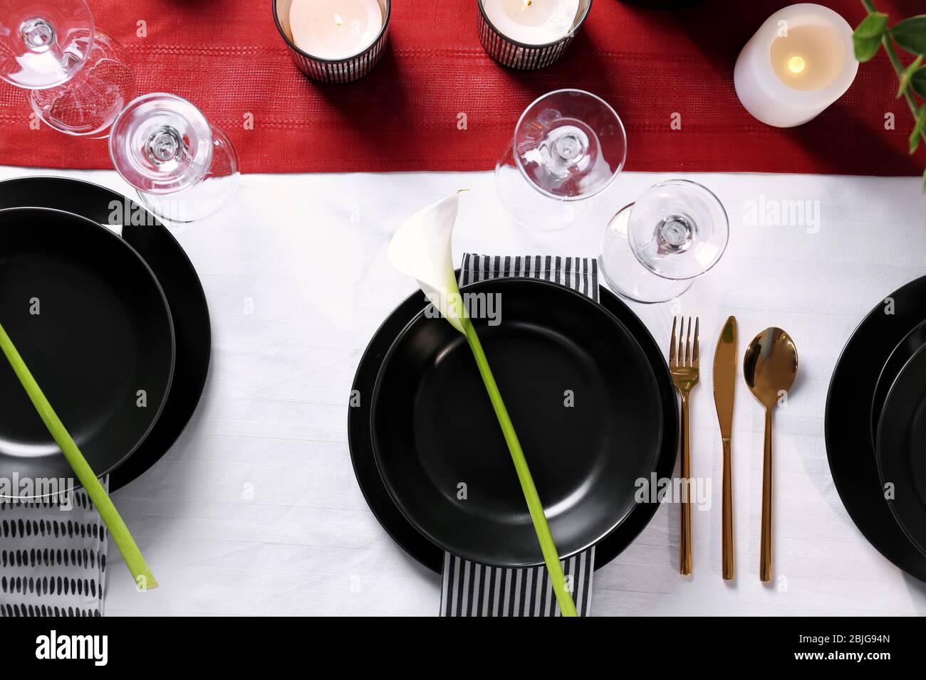 Beautiful table setting with flower and candles Stock Photo - Alamy