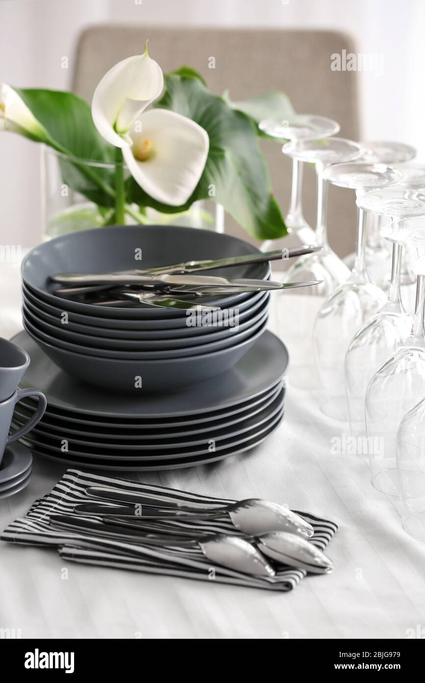 Set of dishware on table in restaurant Stock Photo - Alamy