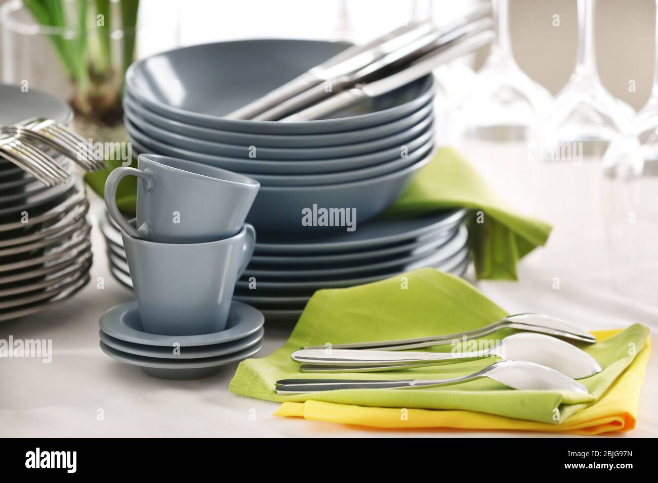 Set of dishware on table in restaurant Stock Photo - Alamy