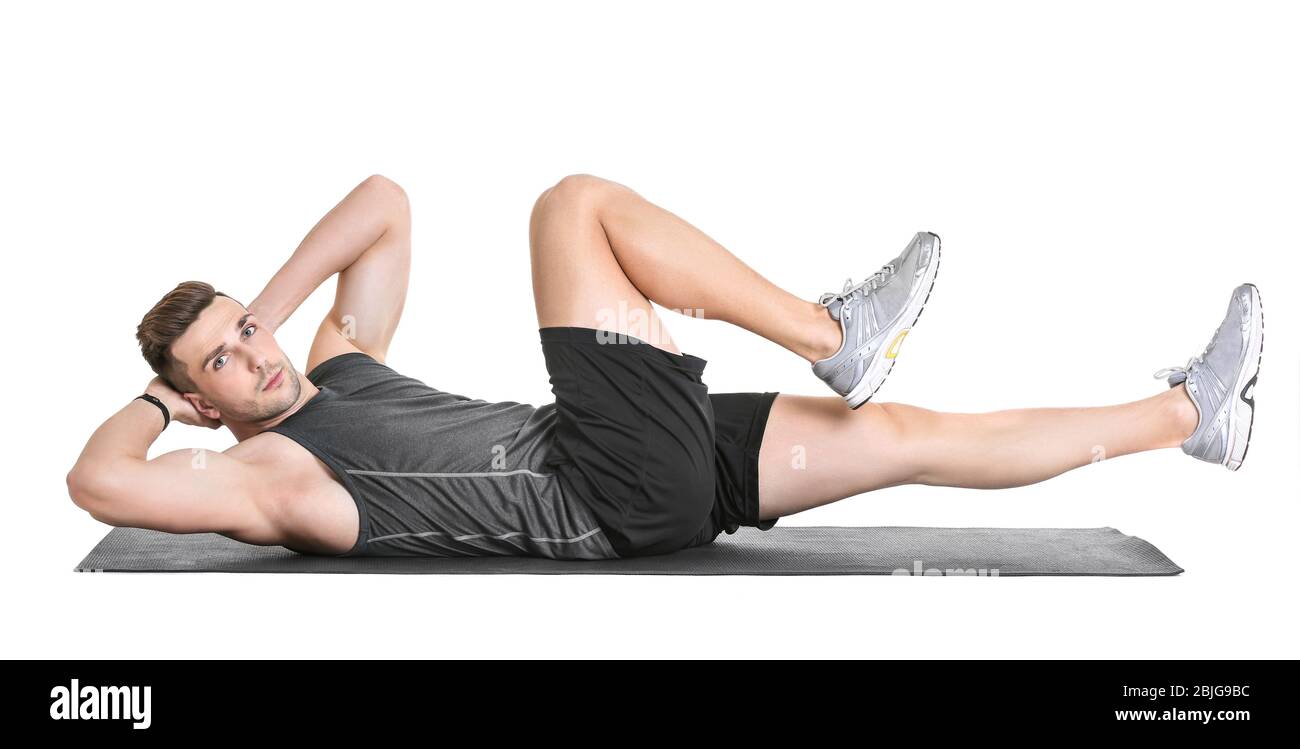 Handsome man doing bicycle crunch on white background Stock Photo - Alamy