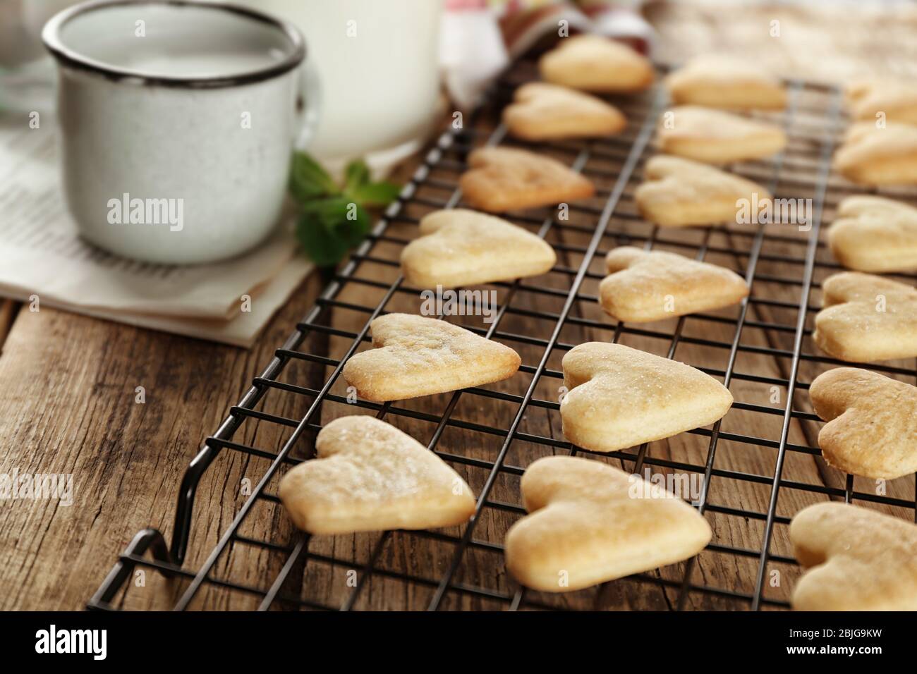 Baking grid with heart shaped butter cookies on table Stock Photo - Alamy