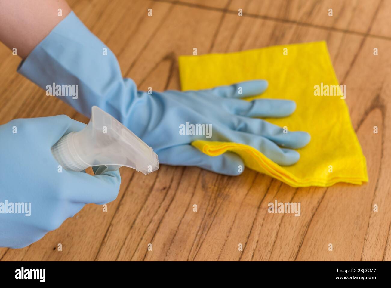 Disinfecting a table surface with rubbing alcohol for prevention of ...
