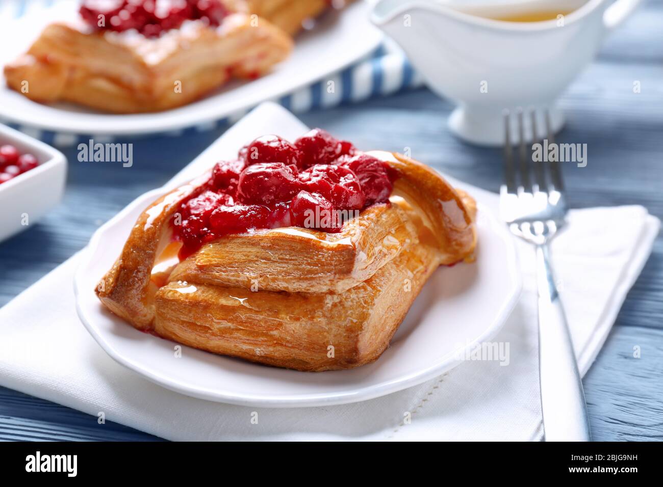 Delicious pastries with berries on served table Stock Photo - Alamy