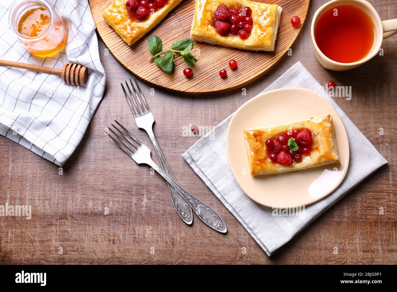 Delicious pastries with berries on served table Stock Photo - Alamy