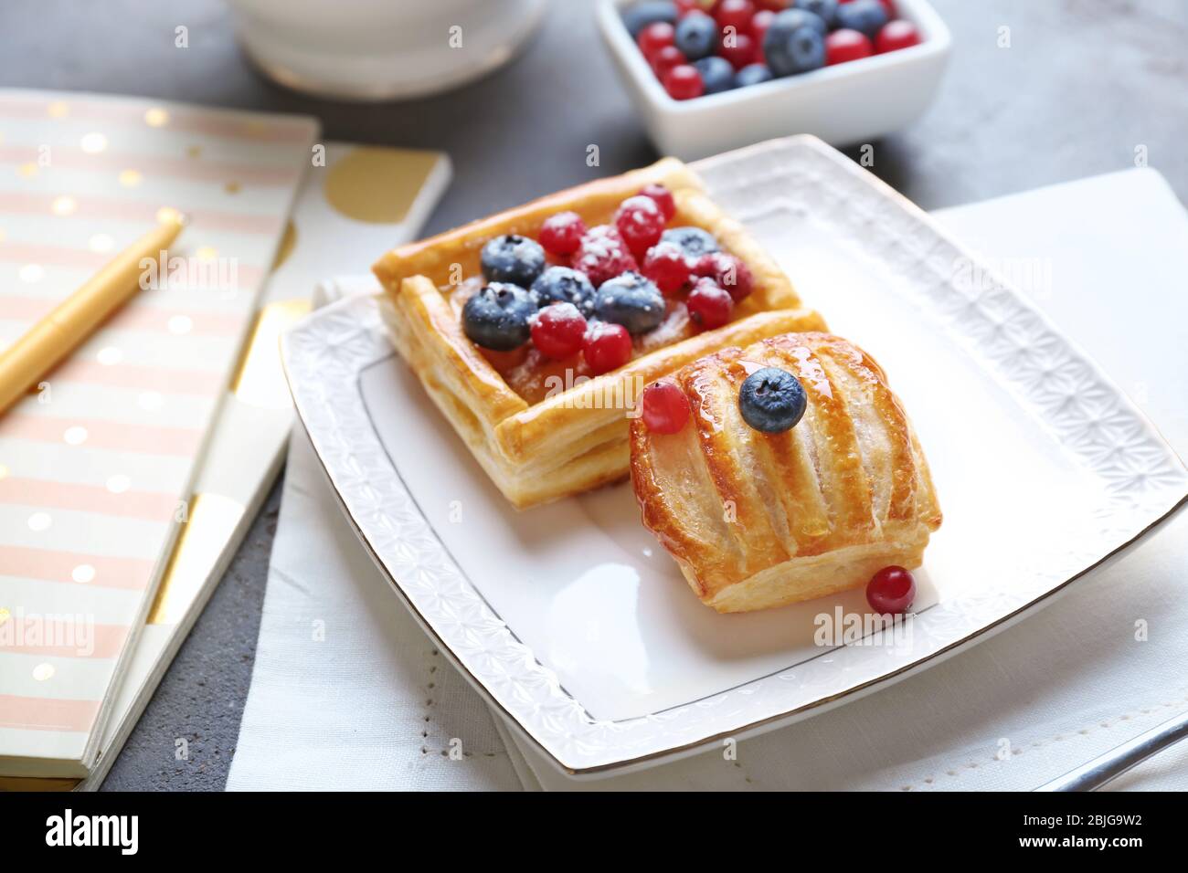 Plate with delicious pastries and berries on served table Stock Photo ...