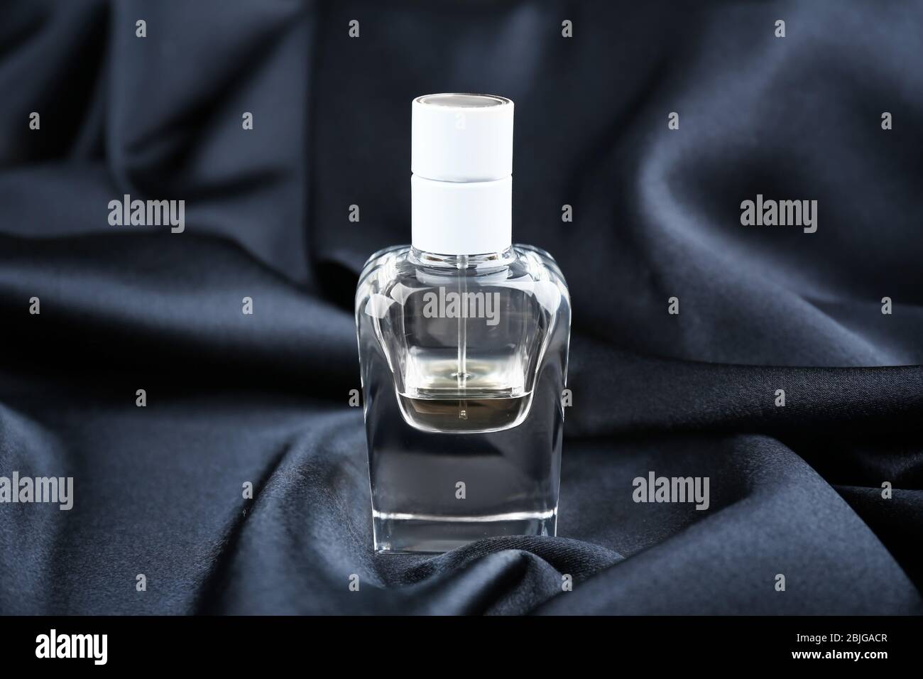 Perfume bottle on cloth Stock Photo - Alamy