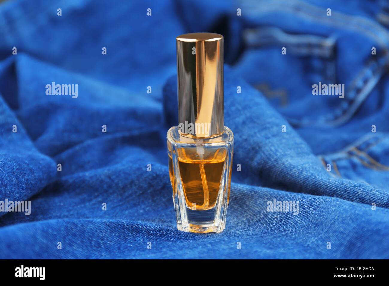 Perfume bottle on denim cloth Stock Photo - Alamy