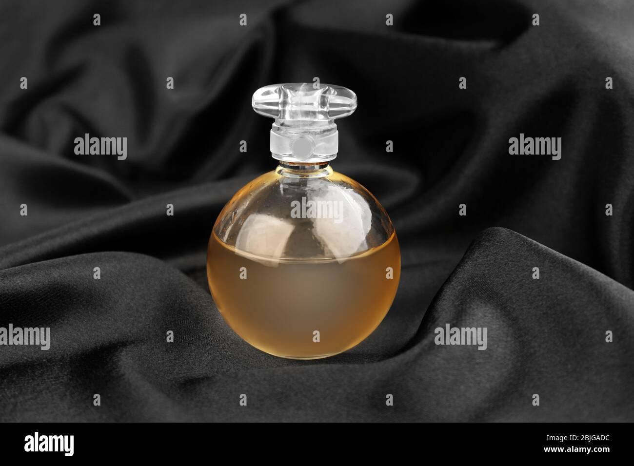 Perfume bottle on cloth Stock Photo - Alamy