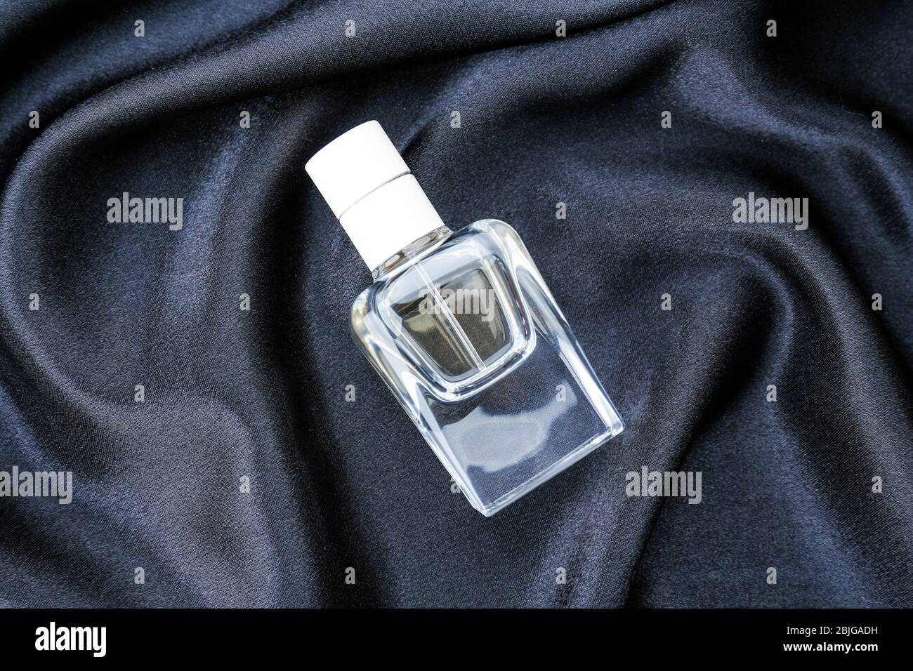Perfume bottle on cloth Stock Photo - Alamy