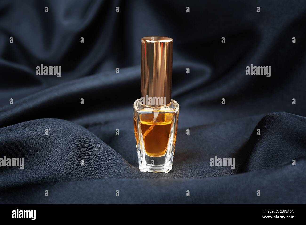 Perfume bottle on cloth Stock Photo - Alamy
