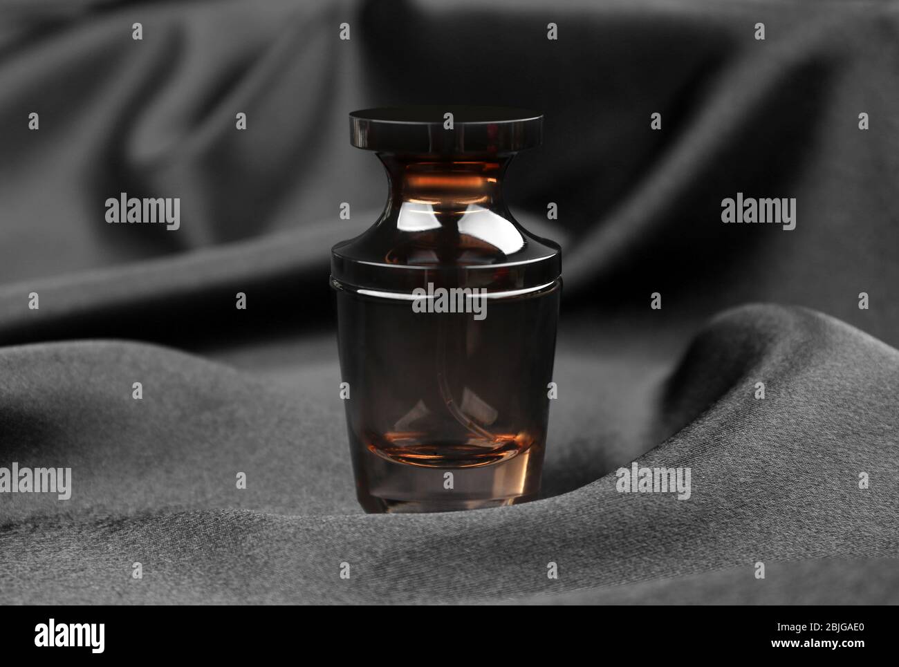 Perfume bottle on cloth Stock Photo - Alamy