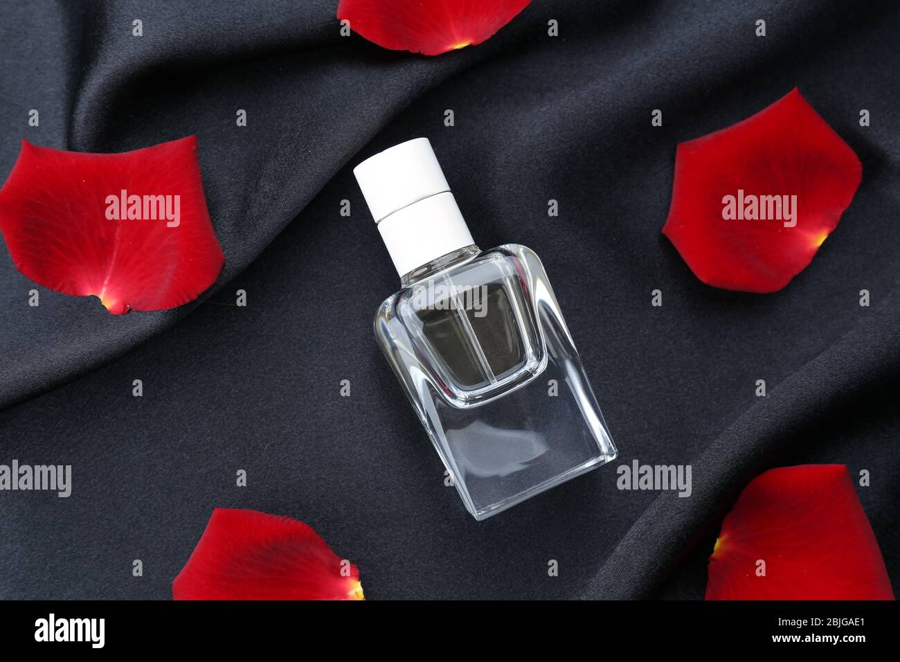 Perfume bottle on cloth Stock Photo - Alamy