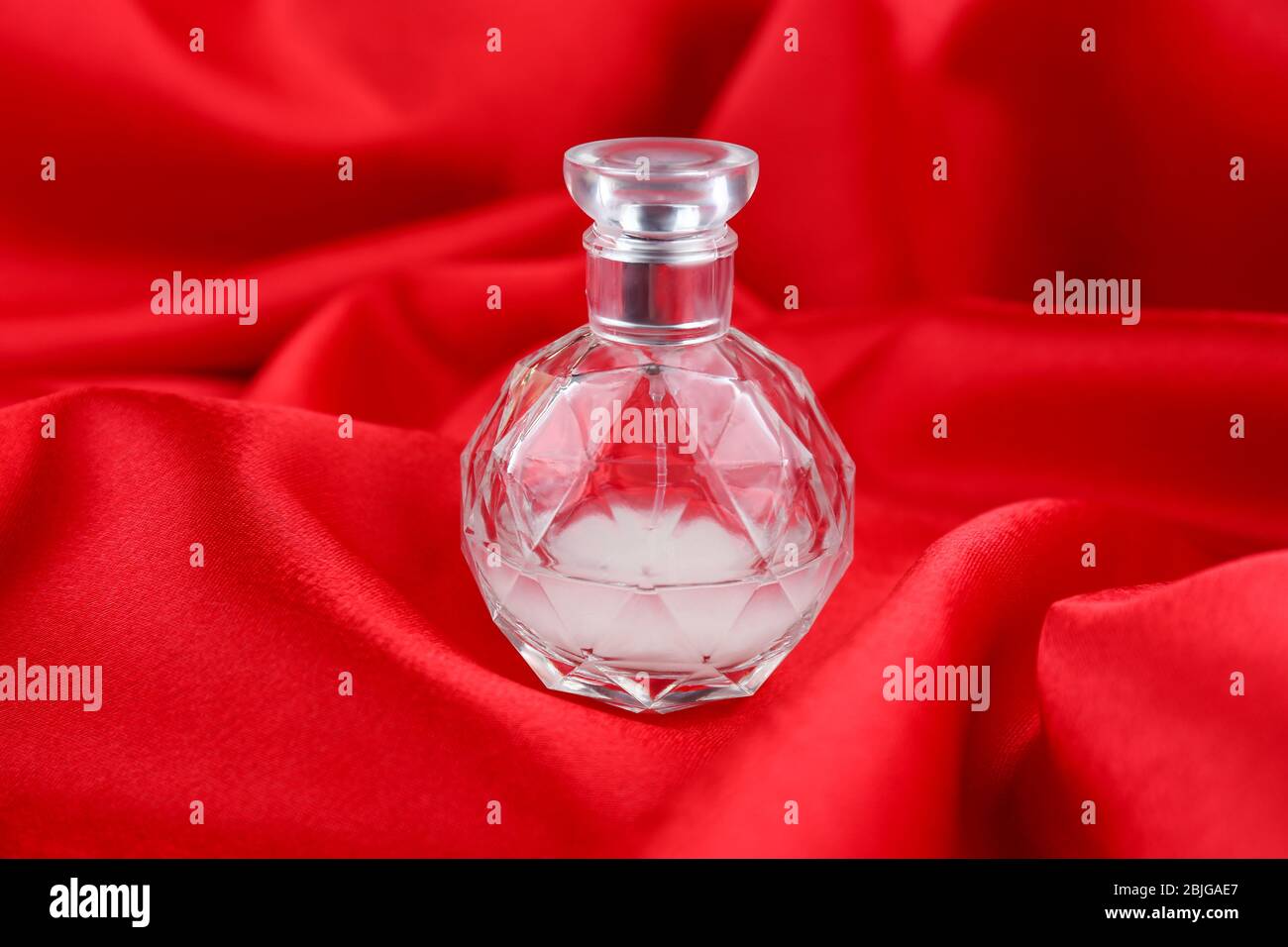 Perfume bottle on cloth Stock Photo - Alamy
