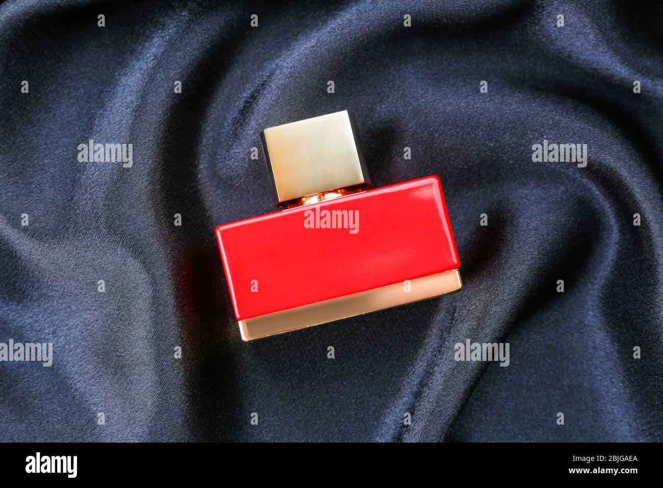 Perfume bottle on cloth Stock Photo - Alamy