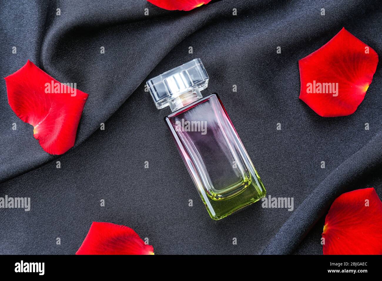 Perfume bottle on cloth Stock Photo - Alamy