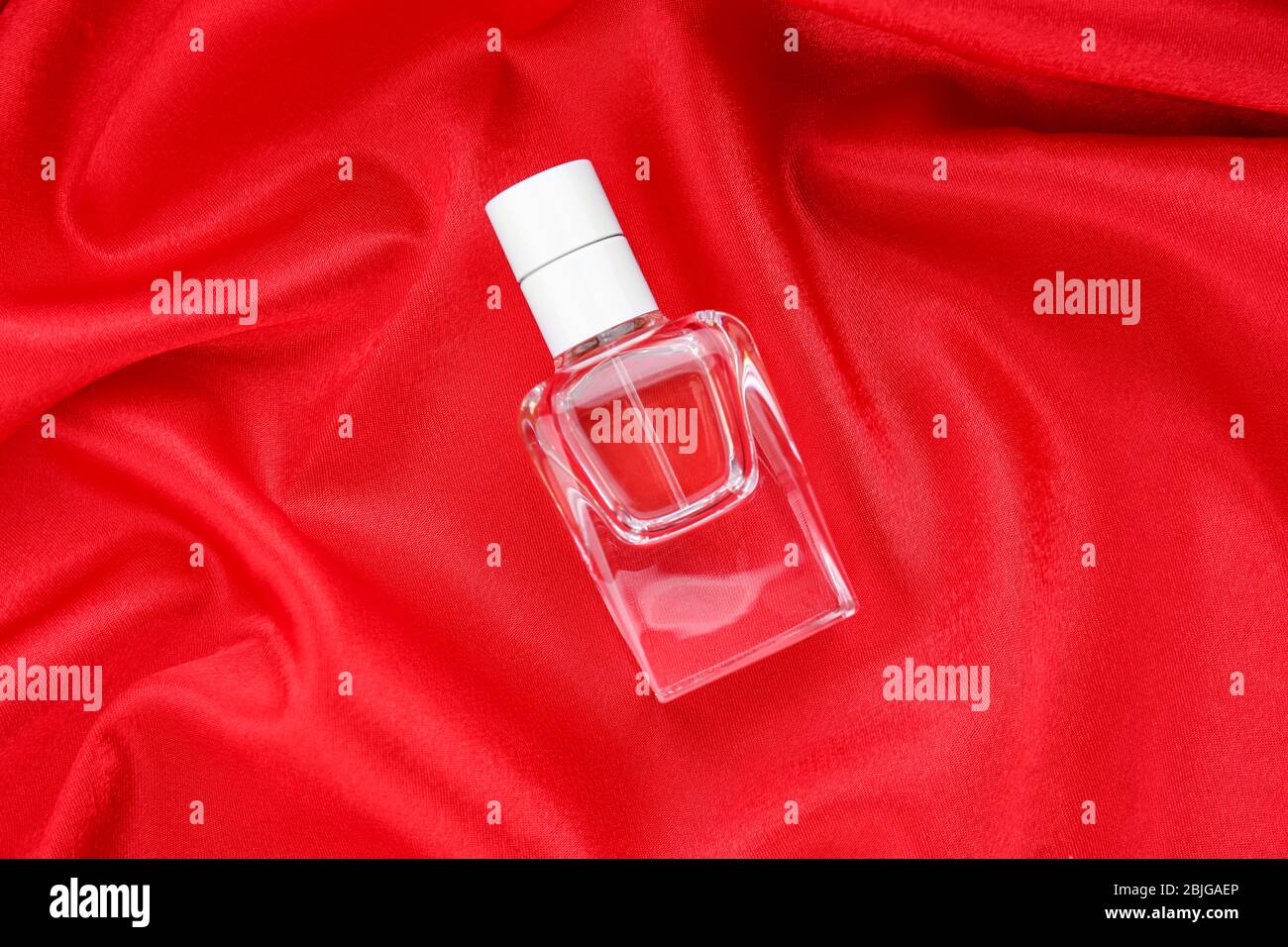 Perfume bottle on cloth Stock Photo - Alamy