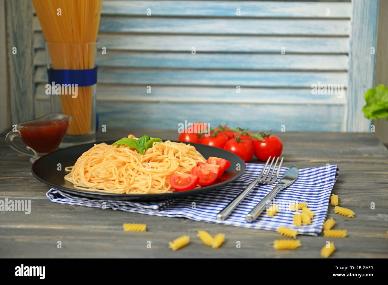 Plate with tasty spaghetti on table Stock Photo - Alamy