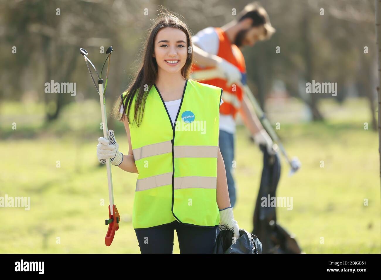 Female volunteer picking up trash hi-res stock photography and images ...