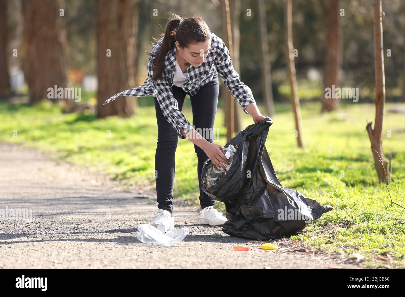 Female picking up litter hi-res stock photography and images - Alamy