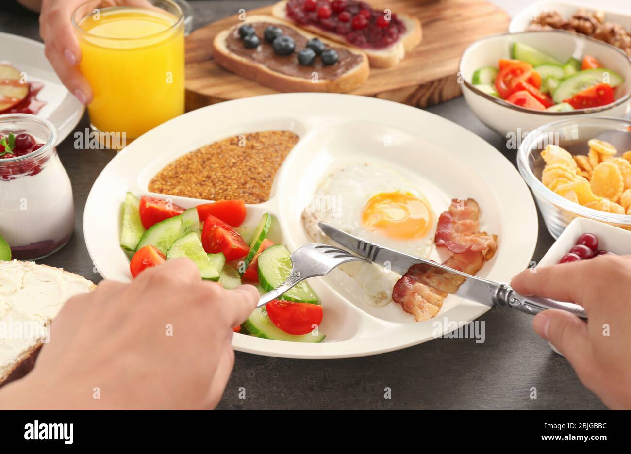 Family having tasty breakfast at table Stock Photo - Alamy