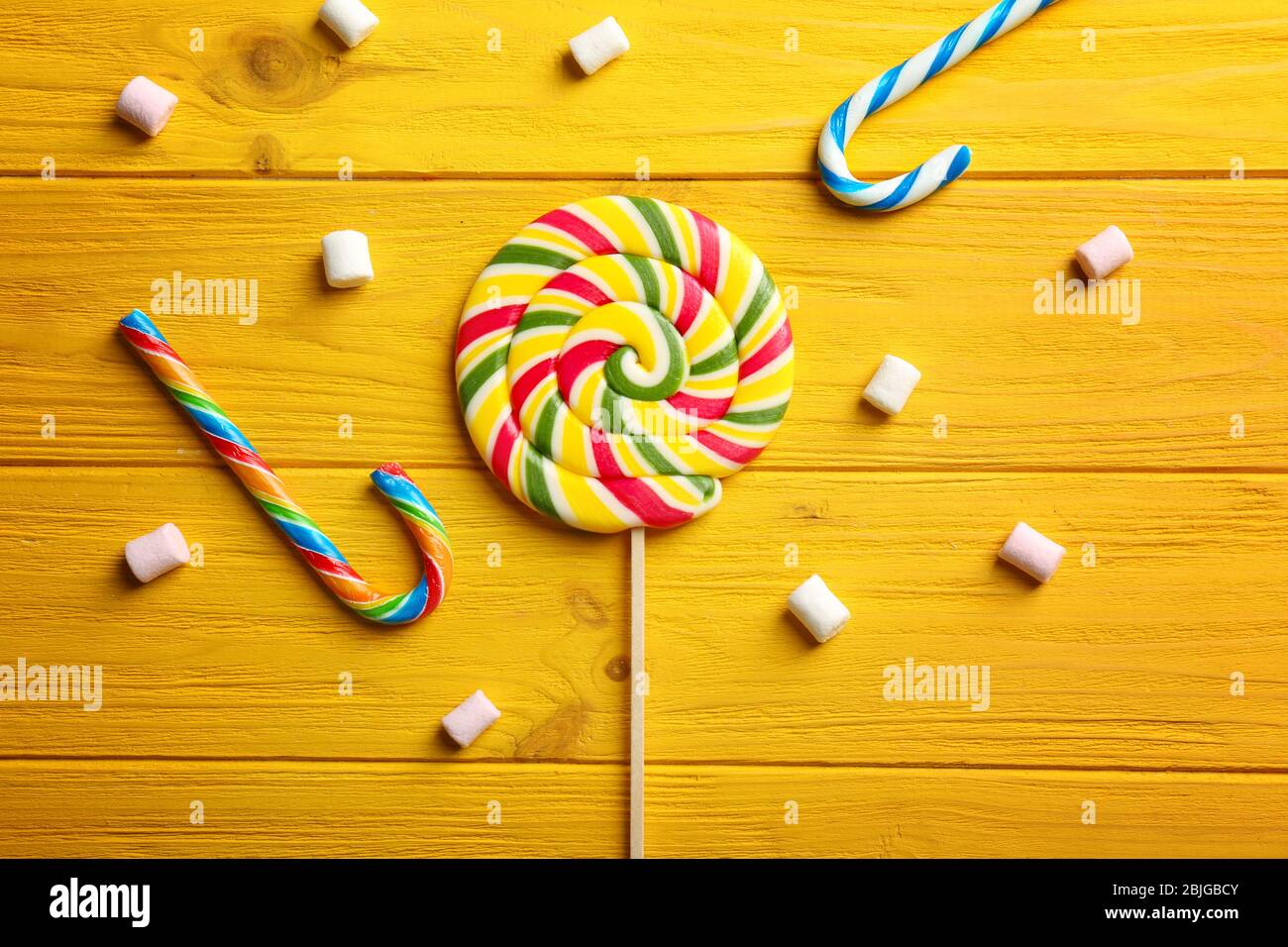 Tasty sweets on color wooden background Stock Photo - Alamy