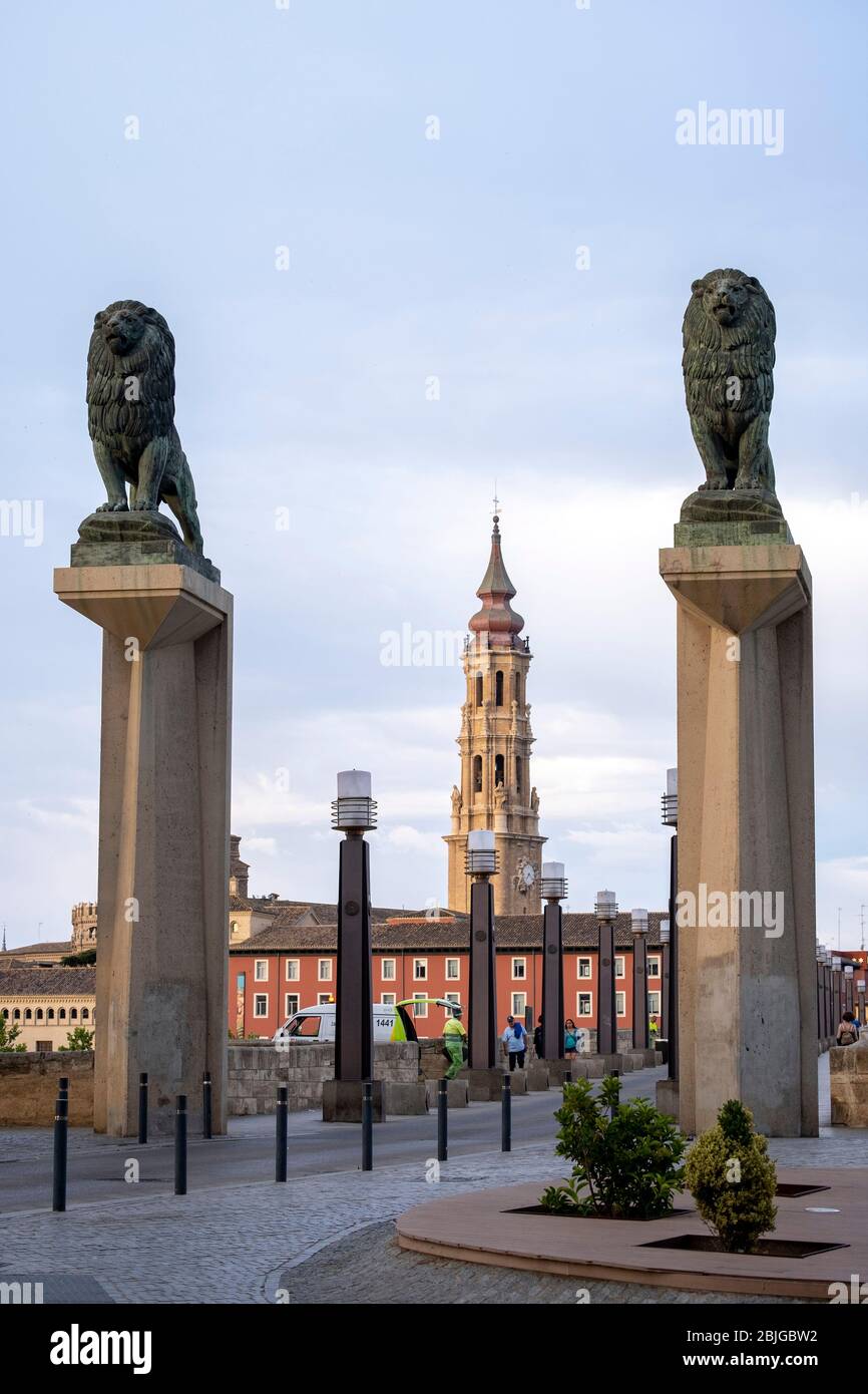Tower of the Catedral del Salvador and bronze statues of lions on the ...
