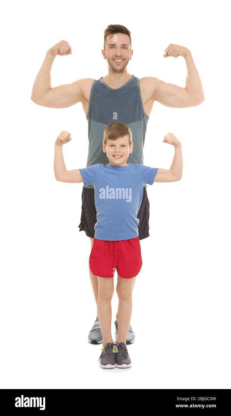 Dad and son showing muscles on white background Stock Photo - Alamy