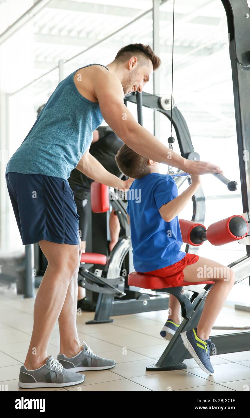 Dad and son training in gym Stock Photo - Alamy