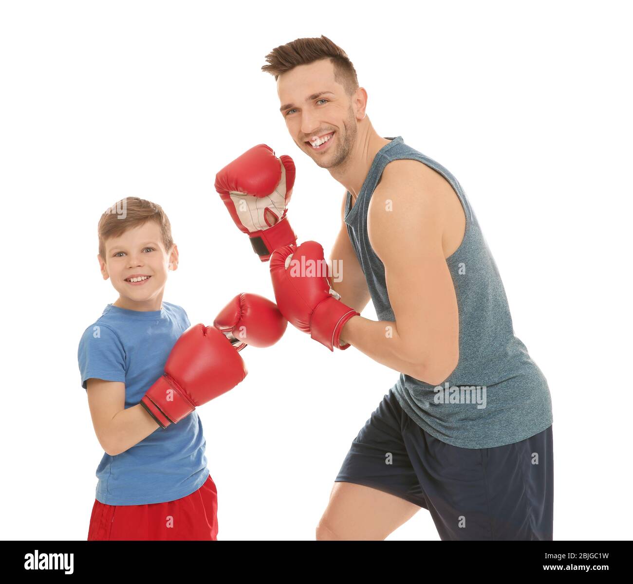 Dad and son in boxing gloves on white background Stock Photo - Alamy