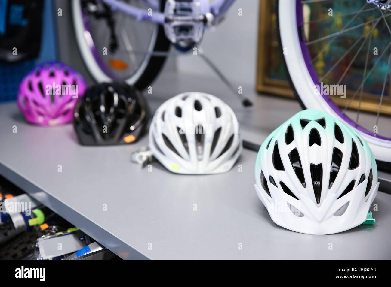 Shelf with bicycle helmets in shop Stock Photo - Alamy