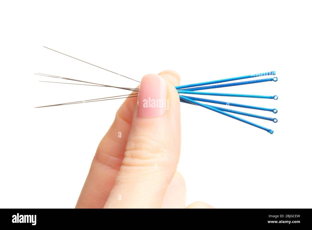 Female fingers with needles for acupuncture on white background ...