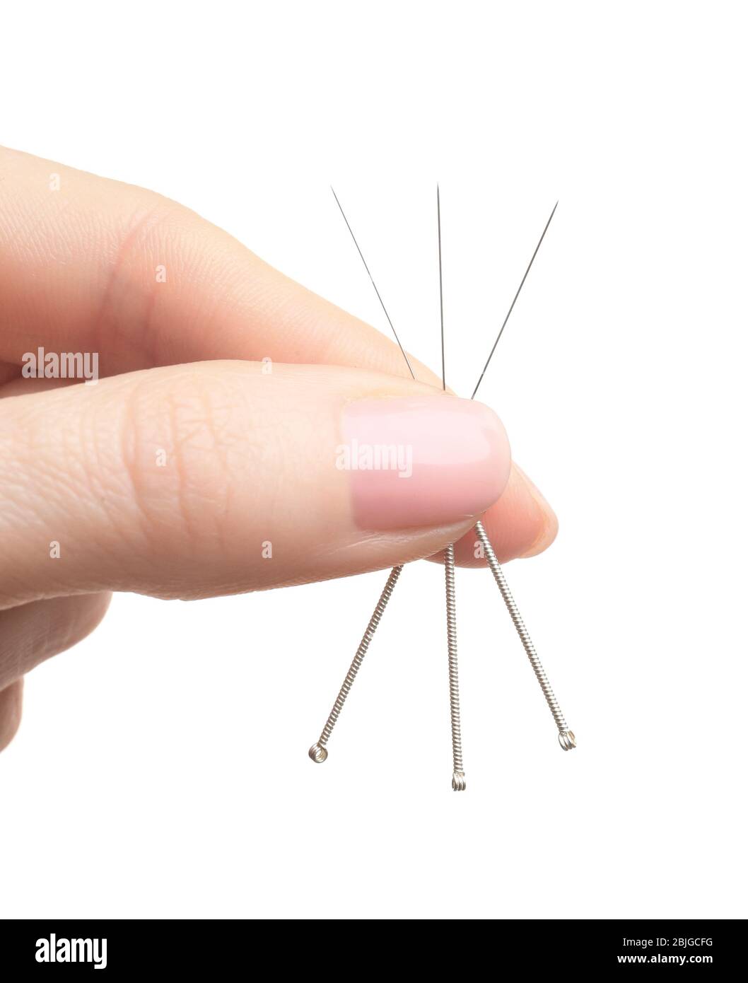 Female hand with needles for acupuncture on white background, closeup ...