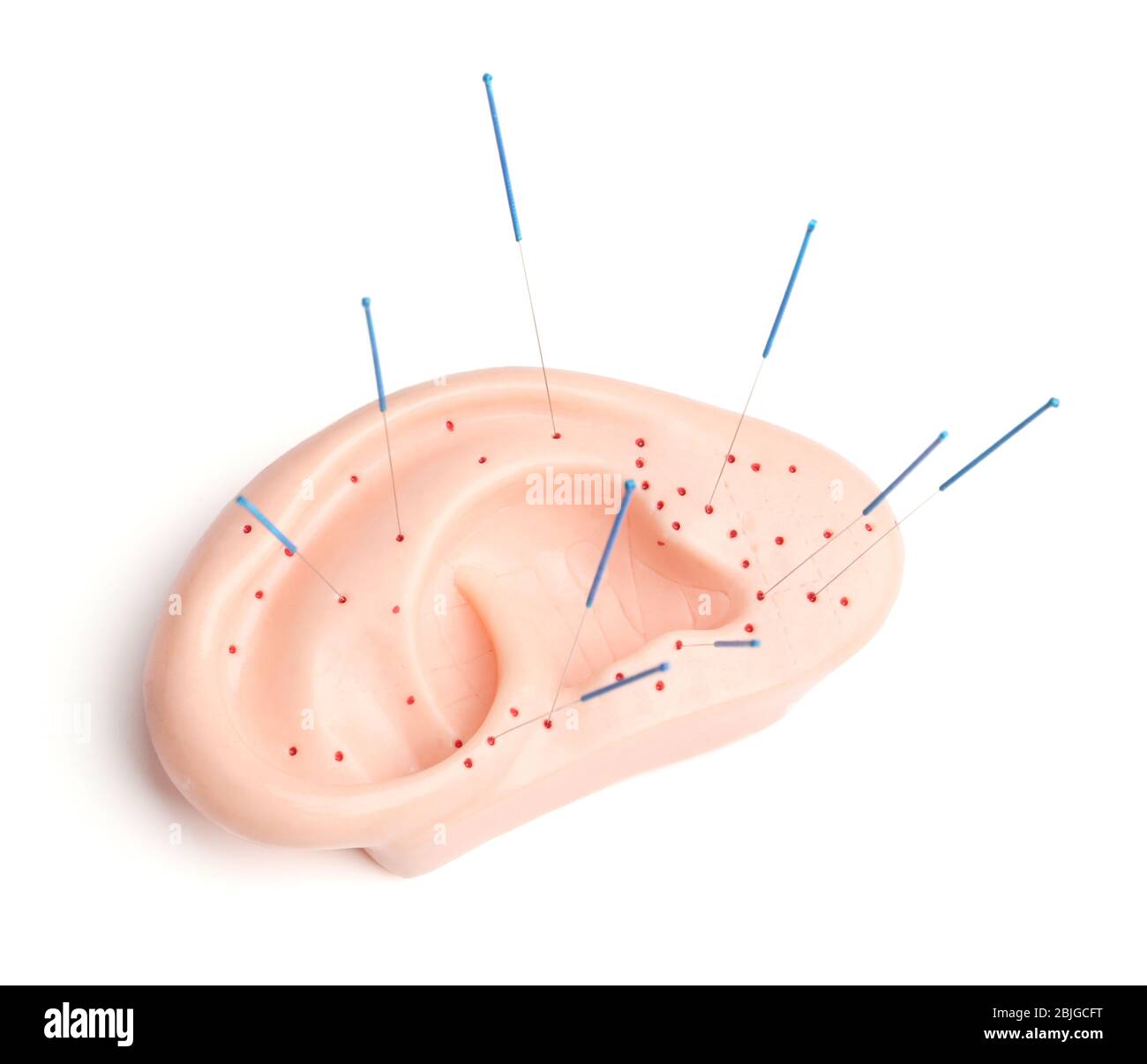 Needles for acupuncture and plastic mockup of human ear on white ...
