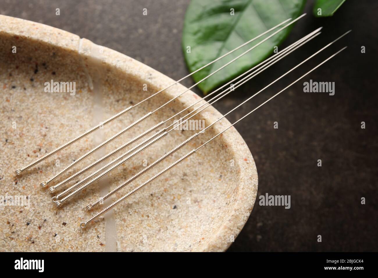 Special stand with needles for acupuncture on dark background, closeup ...