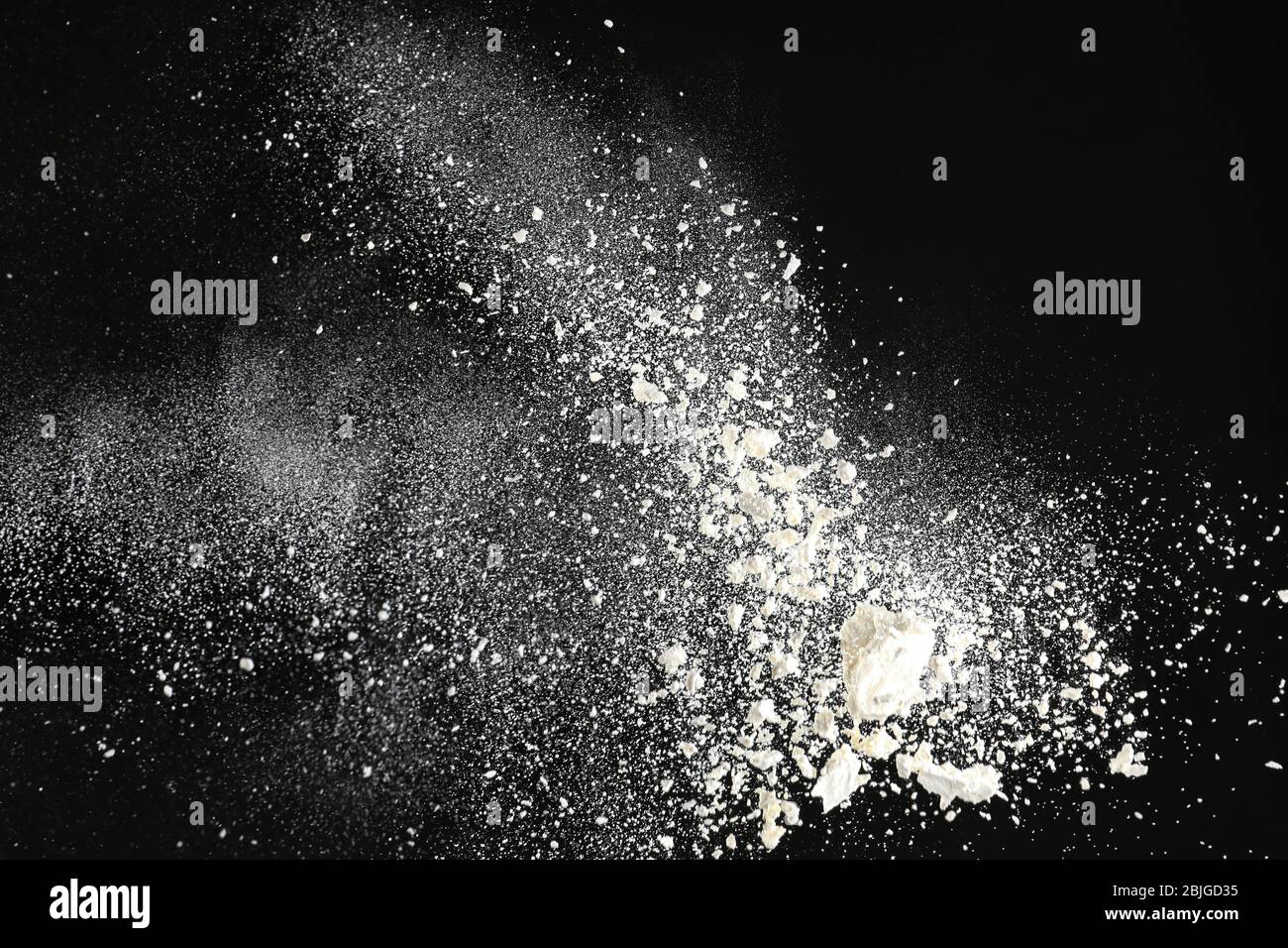Cloud of flour on dark background Stock Photo - Alamy