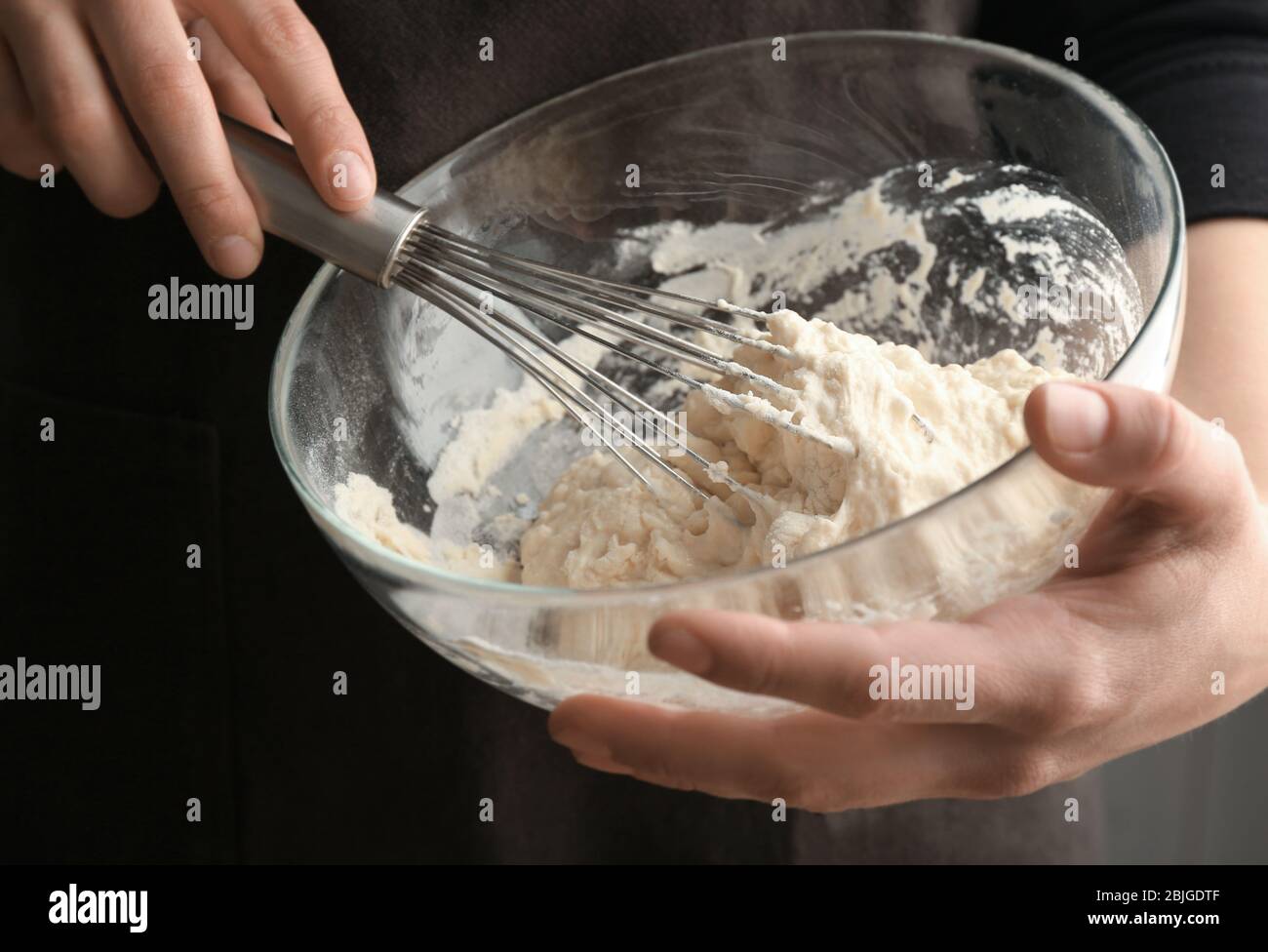 Human hands stirring dough with flour in glass bowl Stock Photo - Alamy
