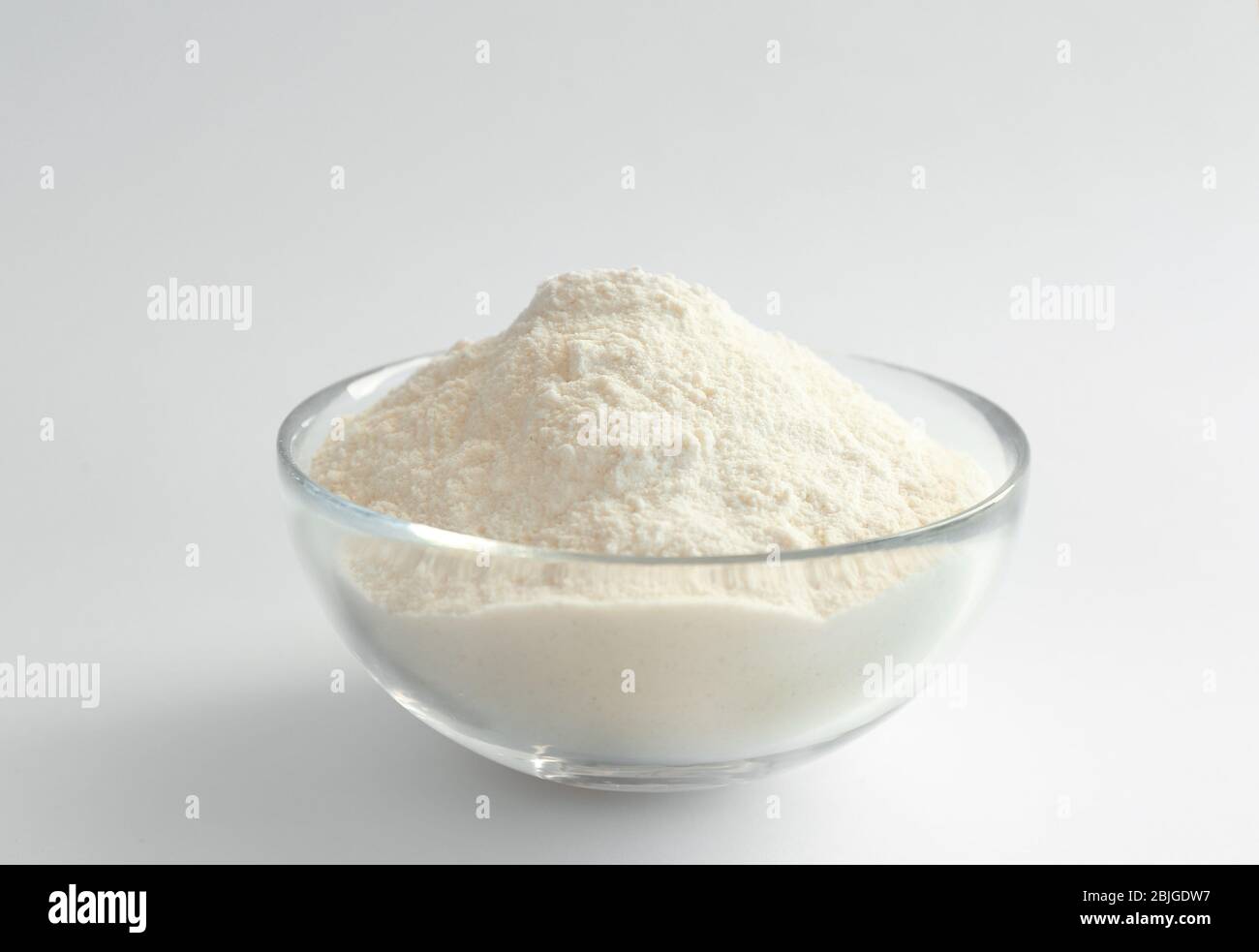 Bowl with flour on white background Stock Photo - Alamy