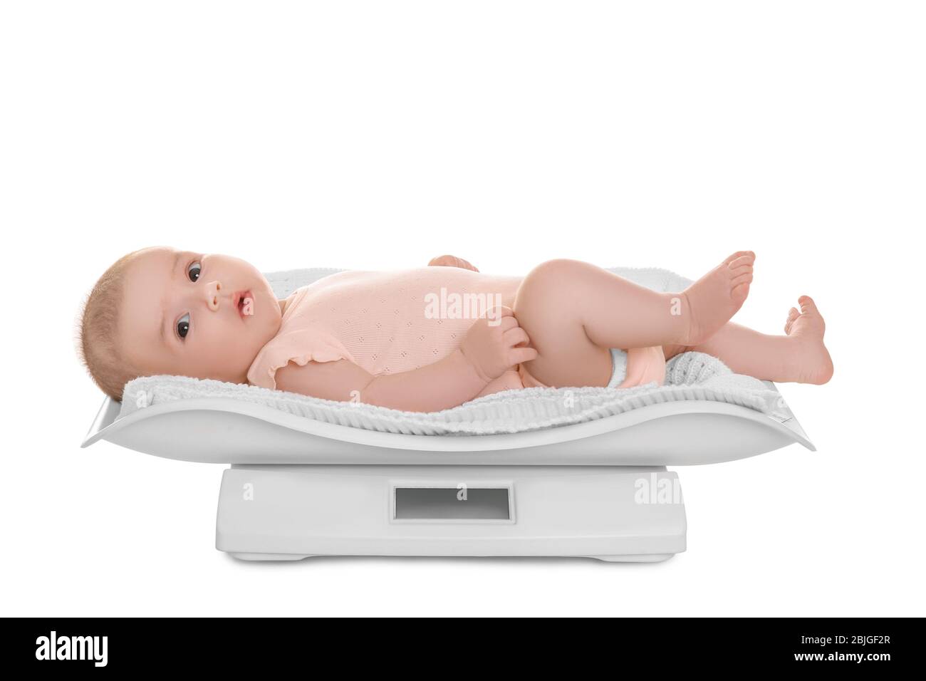 Cute little baby lying on scales against white background Stock Photo ...