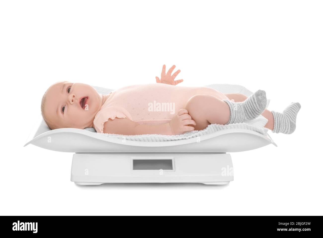Cute little baby lying on scales against white background Stock Photo ...
