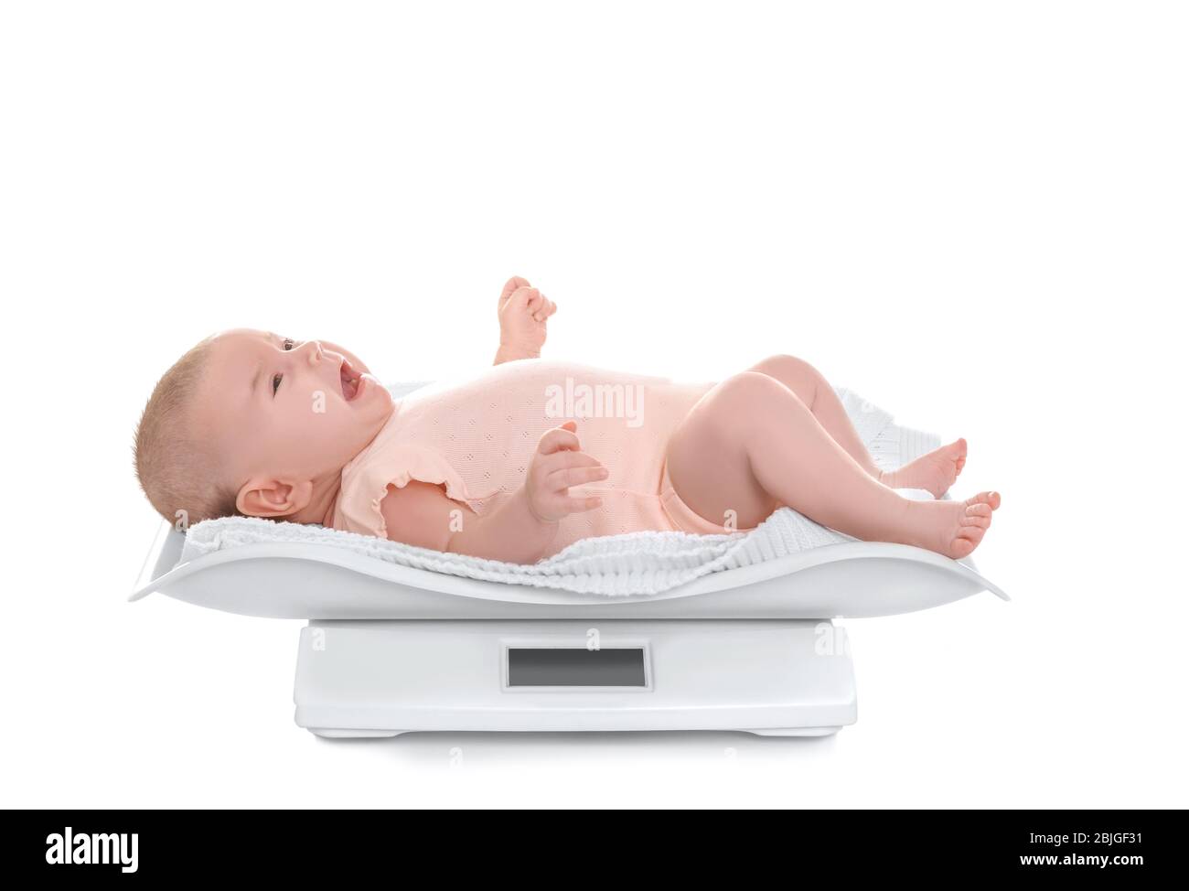 Cute little baby lying on scales against white background Stock Photo ...