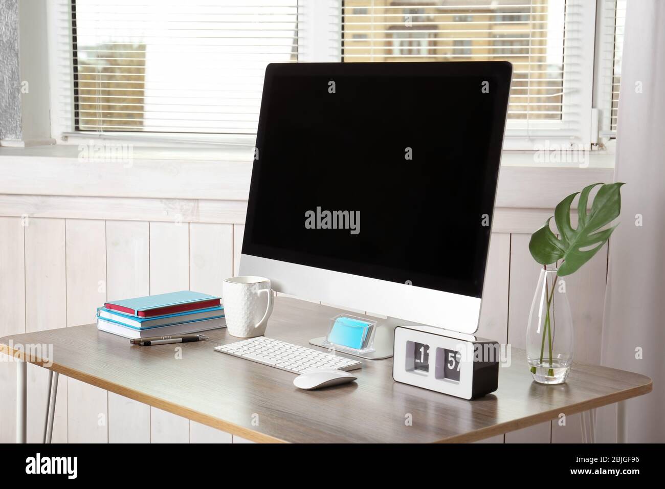 Comfortable workplace with modern monitor and blinds on window Stock ...