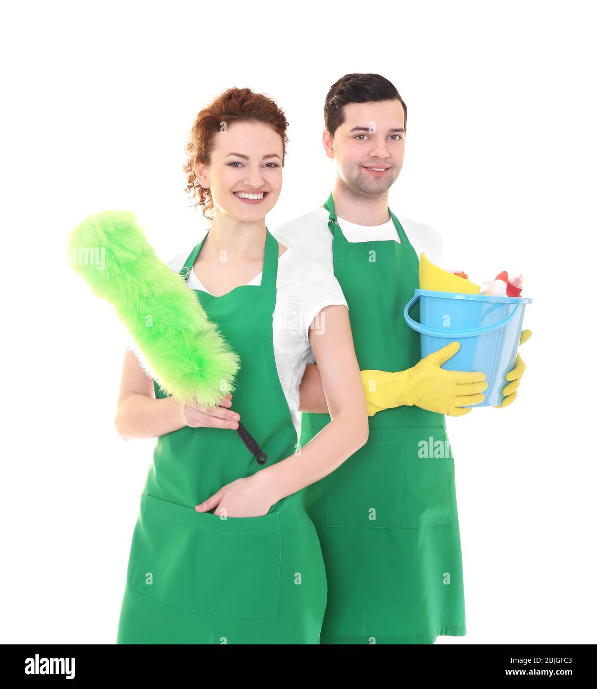 Cleaning staff in green aprons on white background Stock Photo - Alamy