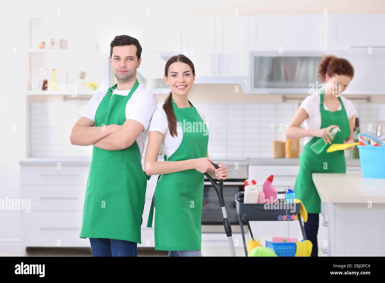 Cleaning service team working in kitchen Stock Photo - Alamy