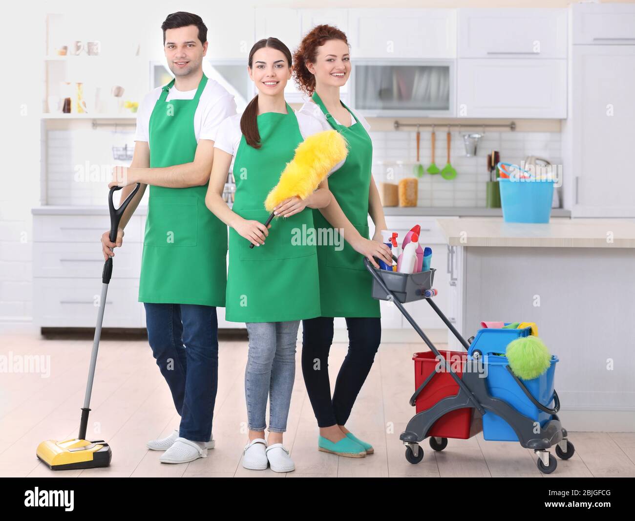 Cleaning service team working in kitchen Stock Photo - Alamy